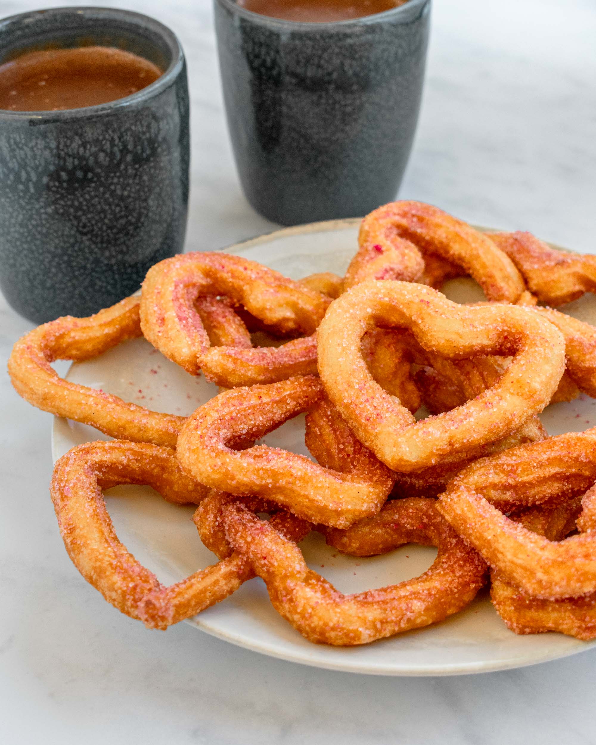 Heart-Shaped Churros with a thick chocolate sauce - Apron & Whisk